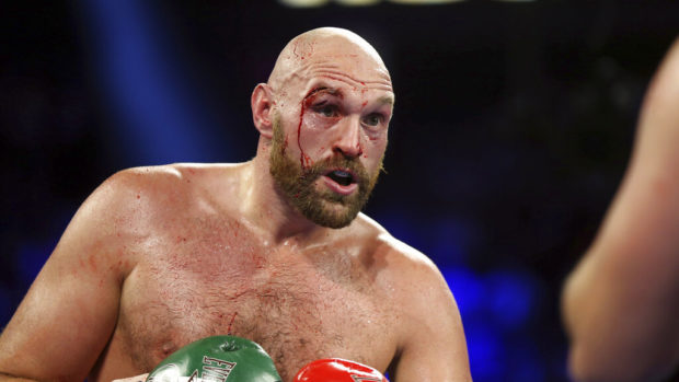 Bloodied but unbowed, Tyson Fury 'ready for war' against Deontay Wilder ...